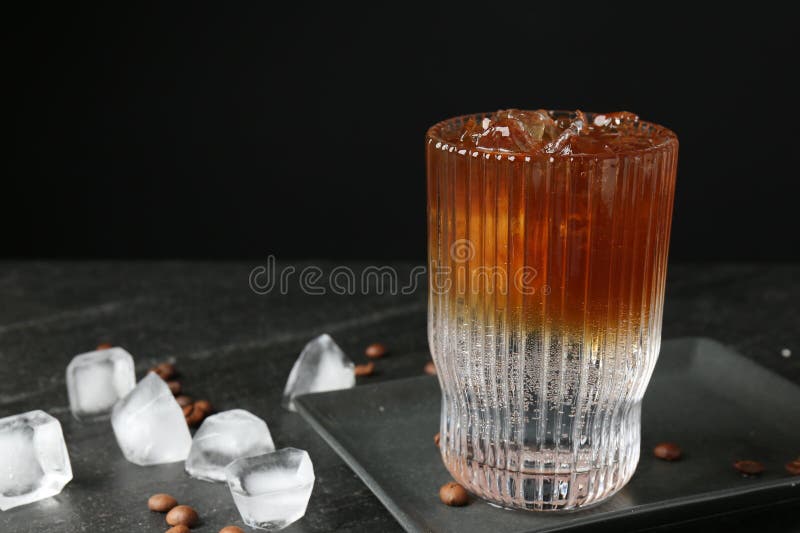 Refreshing Espresso Tonic Drink with Ice and Coffee Beans on Dark Table ...