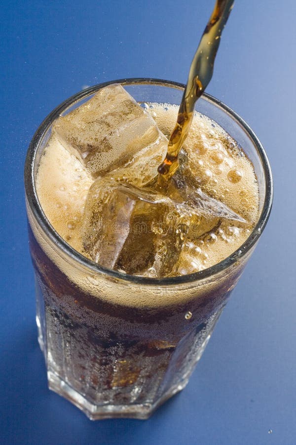 A Refreshing Glass of Beer Over a Beach Resort with Parasols and People ...