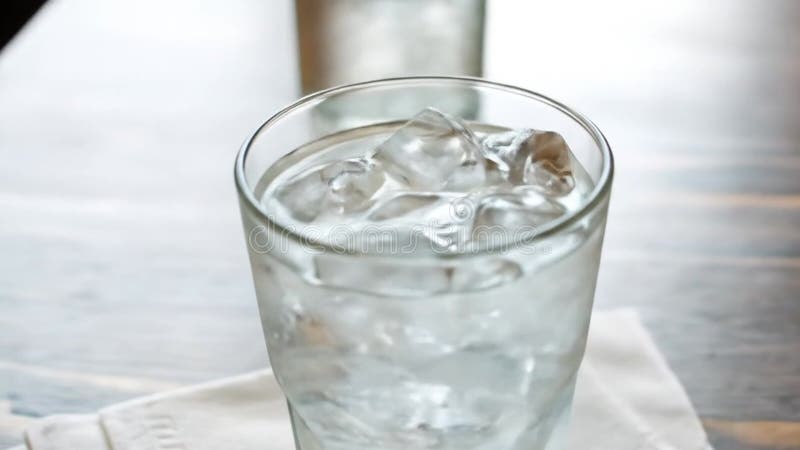 Refreshing Glass of Cold Icy Water on Wooden Table Stock Footage ...