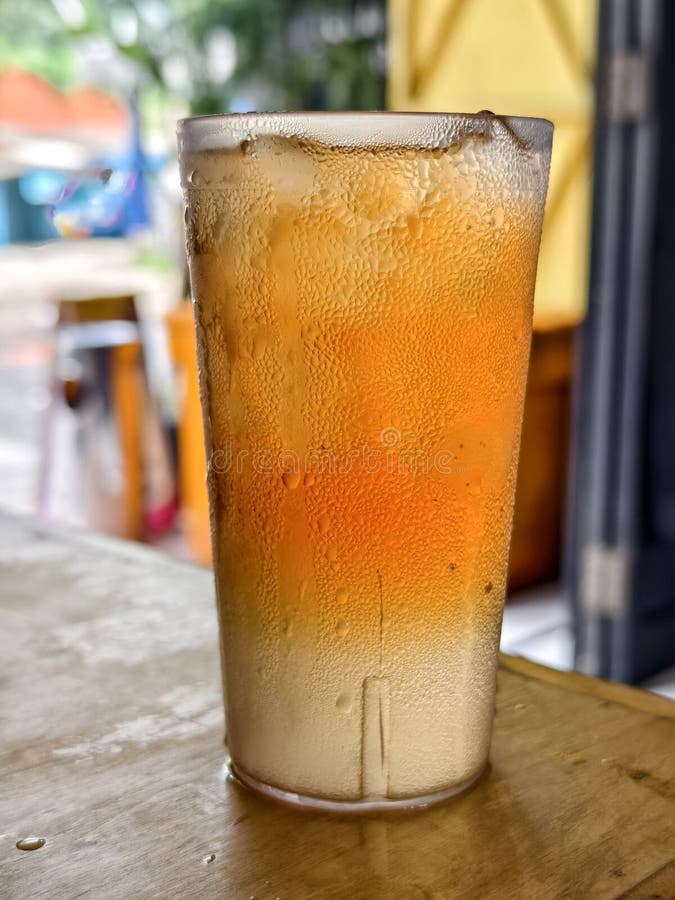 Refreshing Glass of Iced Tea with Ice Cubes and Dew Drops on Surface ...