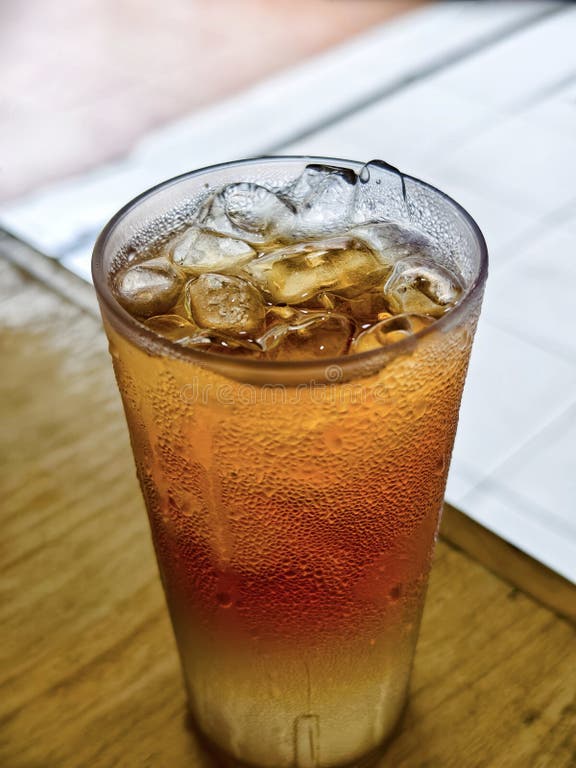 Refreshing Glass of Iced Tea with Ice Cubes and Dew Drops on Surface ...
