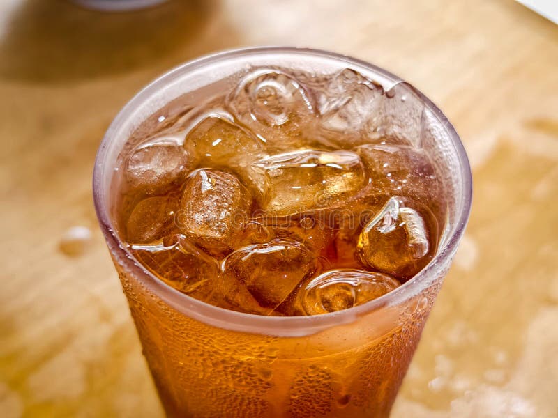 Refreshing Glass of Iced Tea with Ice Cubes and Dew Drops on Surface ...
