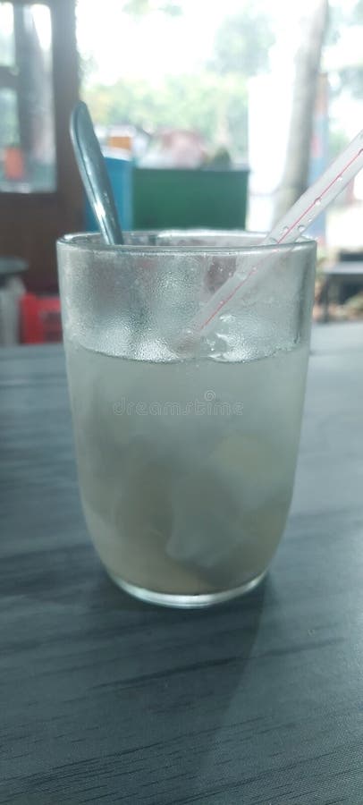 A Refreshing Glass of Young Coconut Ice Drink on a Table Stock Photo ...