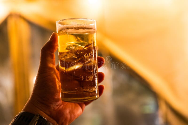 Refreshing Golden Beer in Hand Stock Photo - Image of friendship, beer ...