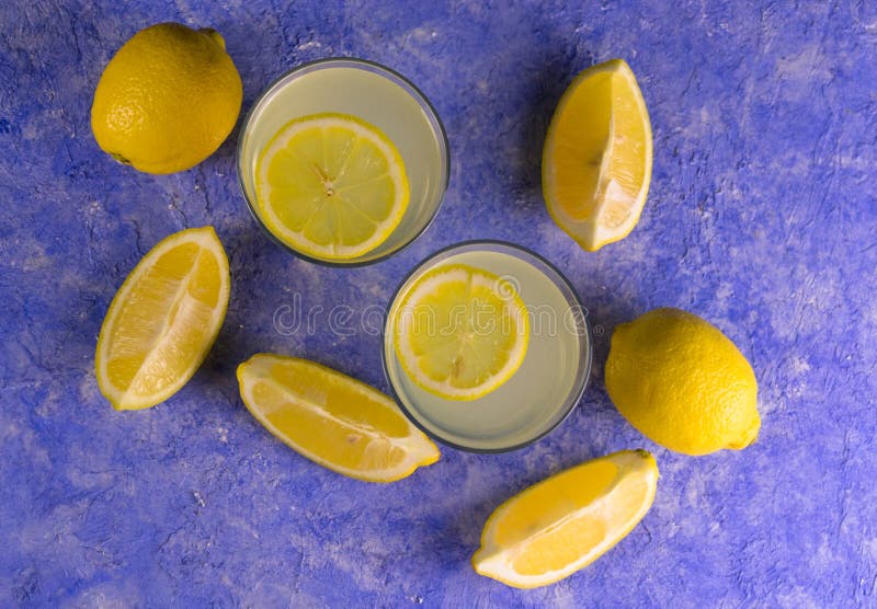 Refreshing Lemonade and Fresh Lemons on a Light Blue Background. Flat ...