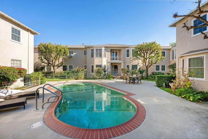 Refreshing Outdoor Pool Surrounded by Lush Greenery and Modern ...