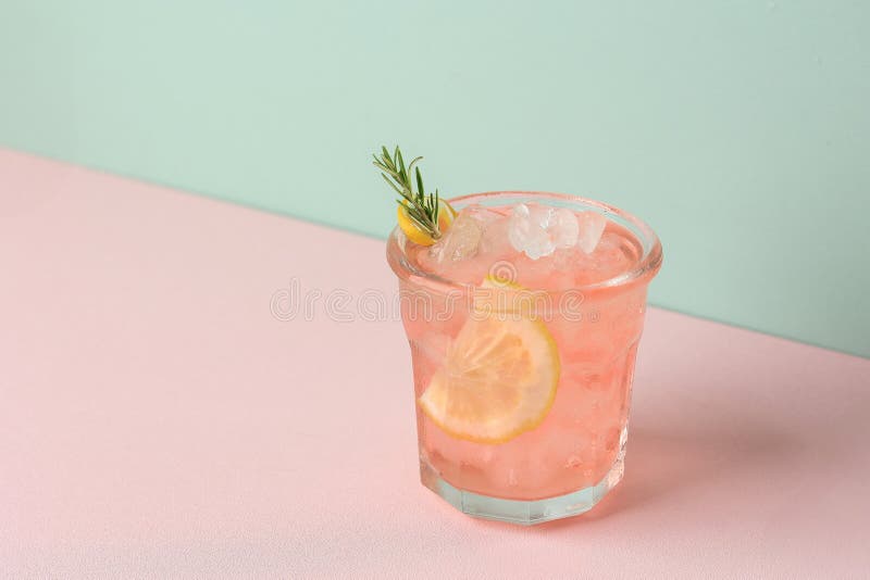 Refreshing Pink Drink or Cocktail with Ice, Garnished with a Slice of ...