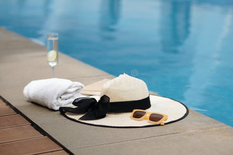 Refreshing Poolside Settings Featuring Hat and Towel Stock Photo ...