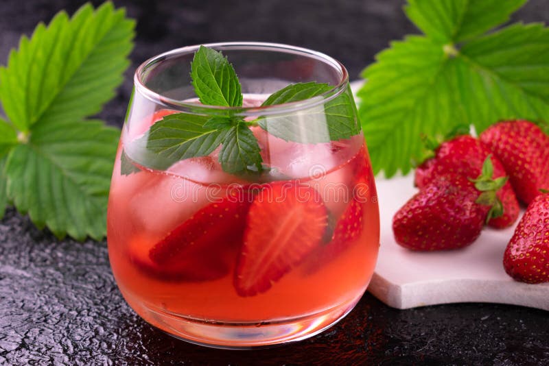 Refreshing Strawberry Drink with Ice and Mint. Close-up. Stock Photo ...