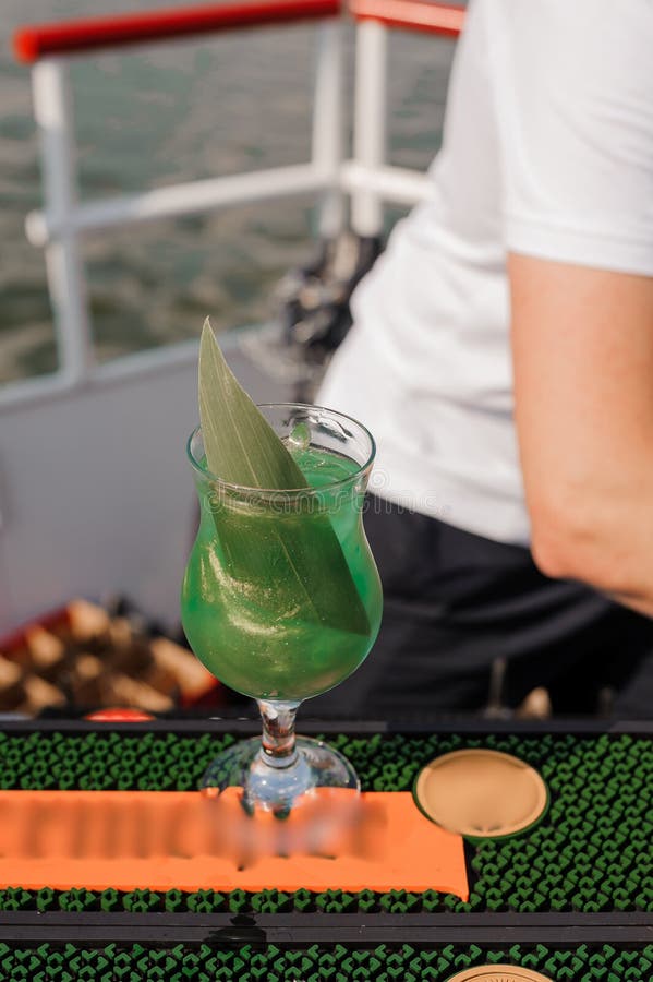 Refreshing Tropical Drink on a Sunny Boat Deck with Lush Garnish Stock ...