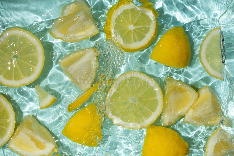 Refreshing Turquoise Citrus Background with Floating Yellow Lemon ...