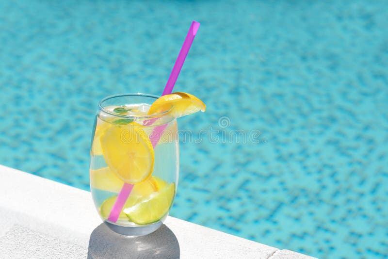 Refreshing Water with Lemon Slices and Mint Near Swimming Pool. Space ...