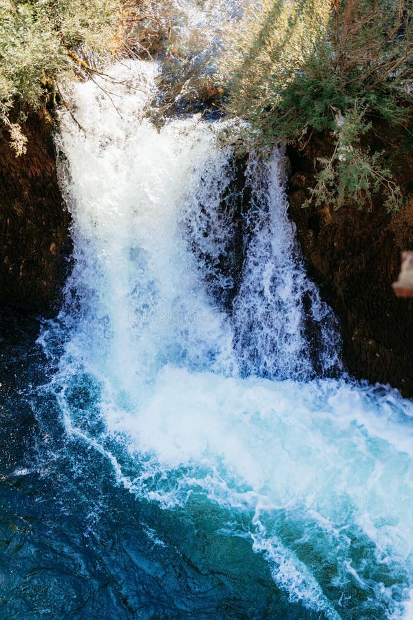 Refreshing Waterfall Cascading into a Clear Blue Pool Stock Image ...