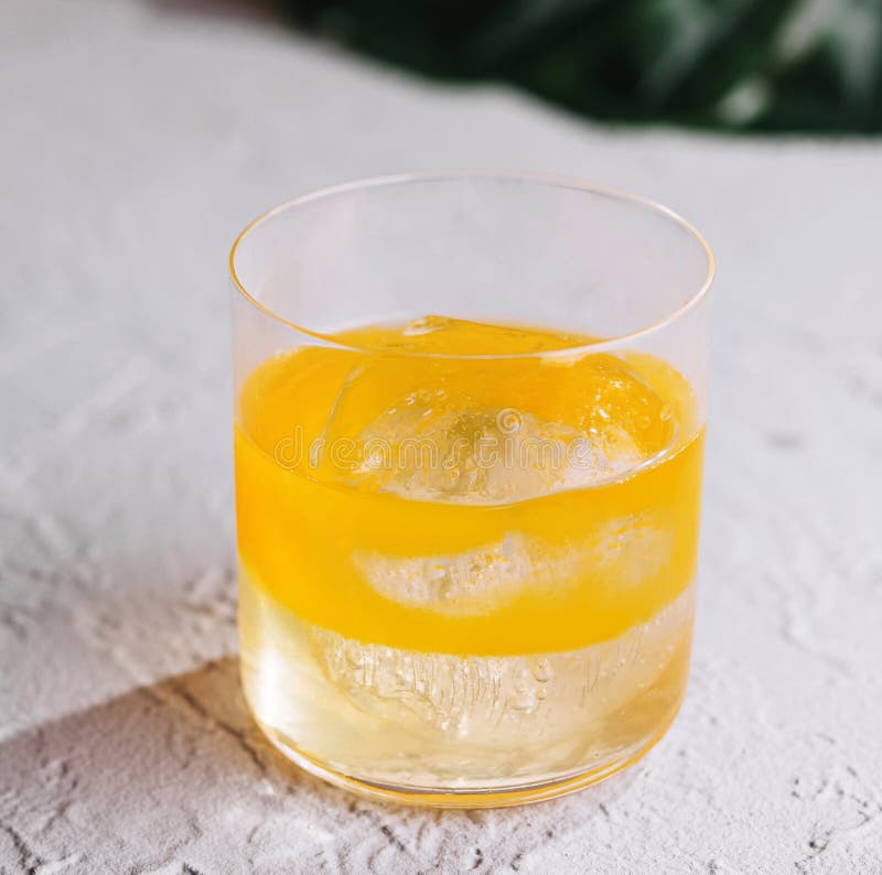 Refreshing Yellow Cocktail Standing on White Background with Tropical ...