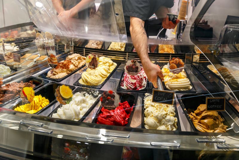 Refrigerated Display Case with a Large Assortment of Soft Ice Cream in ...