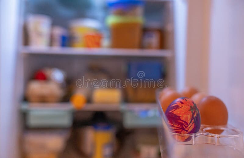 Refrigerator Shelf with Regular Eggs and One Painted Stock Image ...
