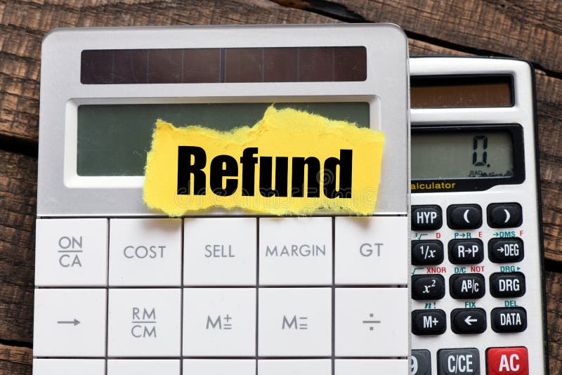 REFUND Word on a Small Yellow Sheet of Paper Placed on the Calculator ...