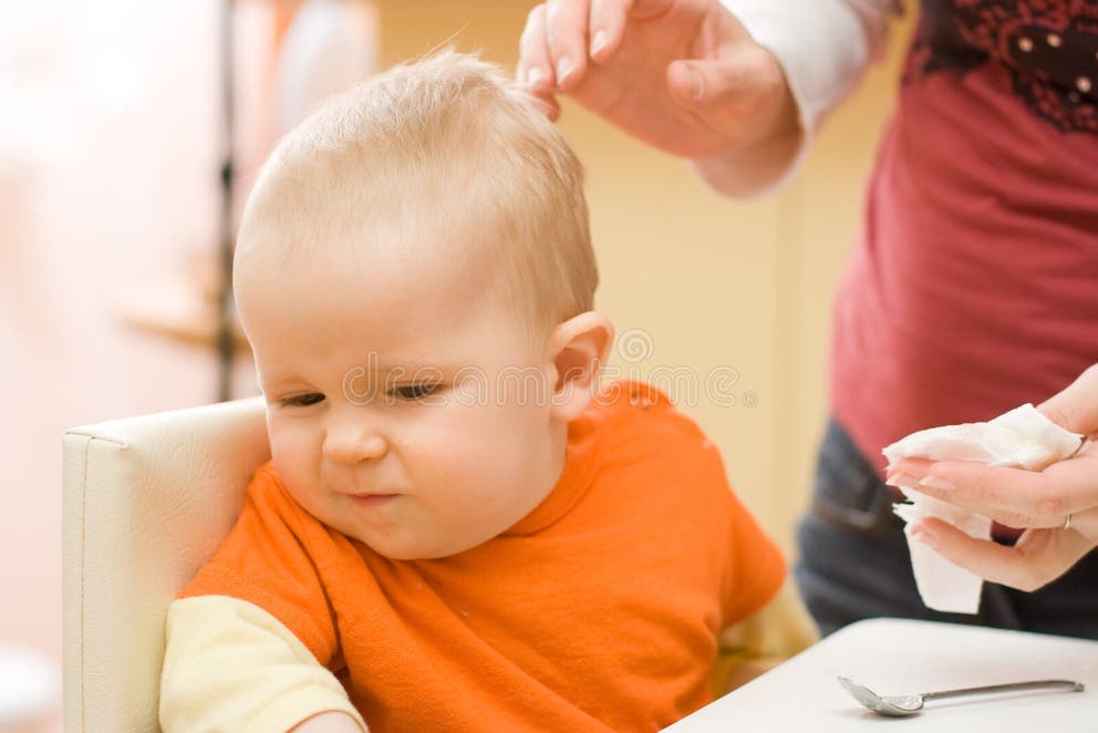 Refusing to be wiped stock image. Image of baby, expression - 4355437
