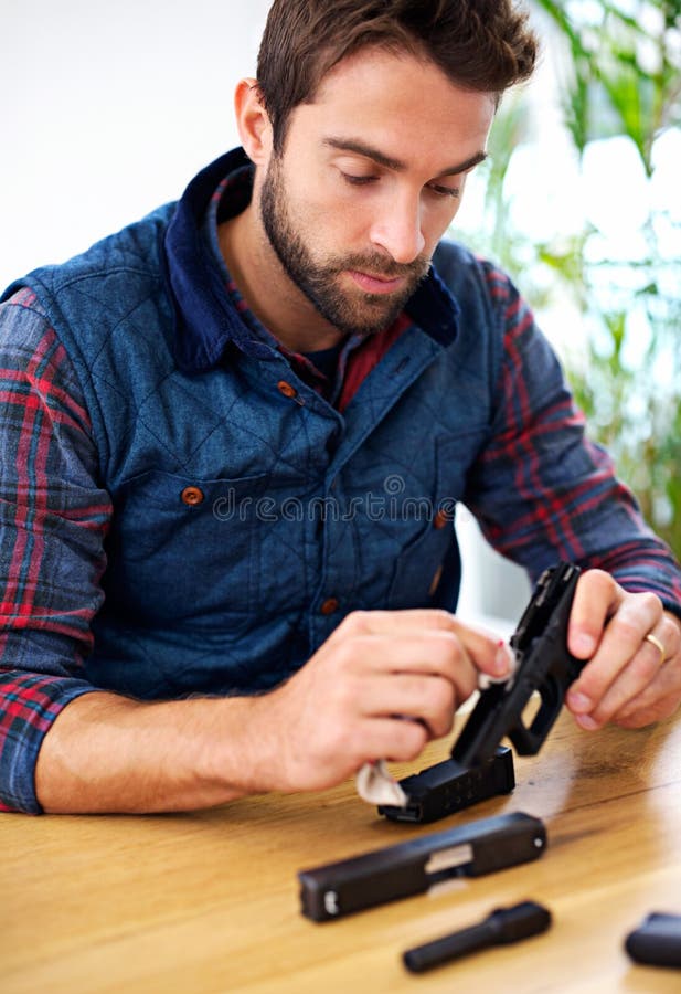 Regular Maintenance is Essential for Every Gun Owner. a Young Man ...