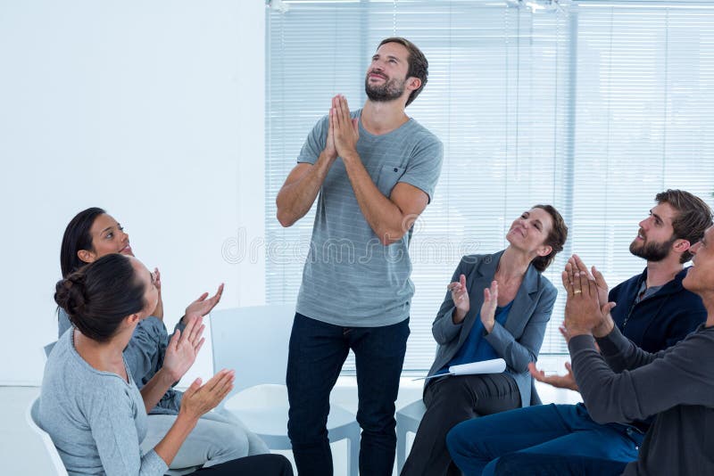 Rehab Group Applauding Delighted Man Standing Up Stock Image - Image of ...