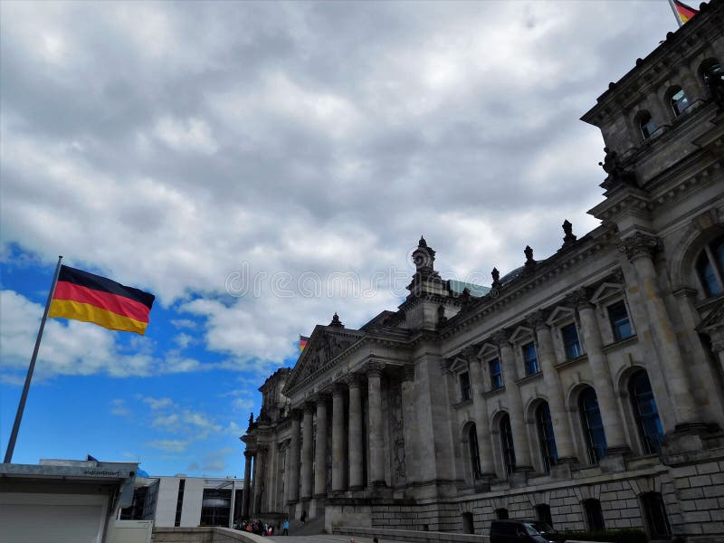 Reichstag Building with the German Flag Blowing in the Wind in Front ...