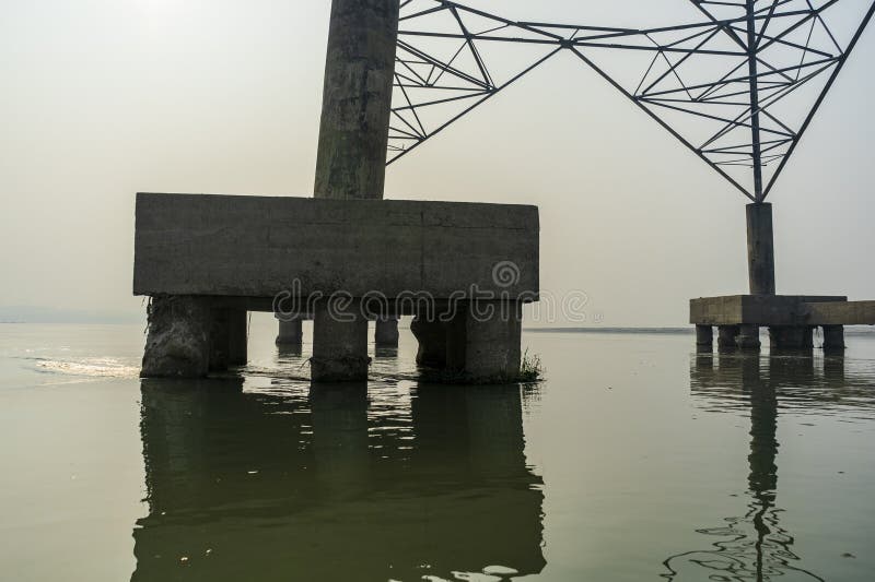 Reinforced Concrete Power Line Support Across the River, Located in the ...