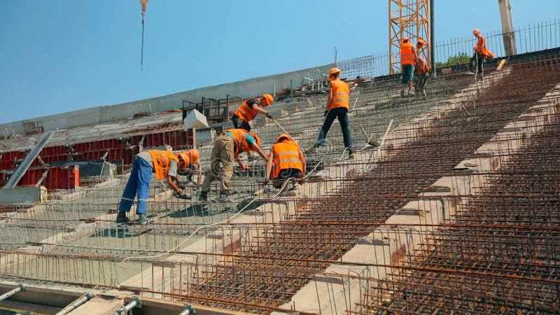Working Process at a Construction Site. Workers Make a Reinforced ...