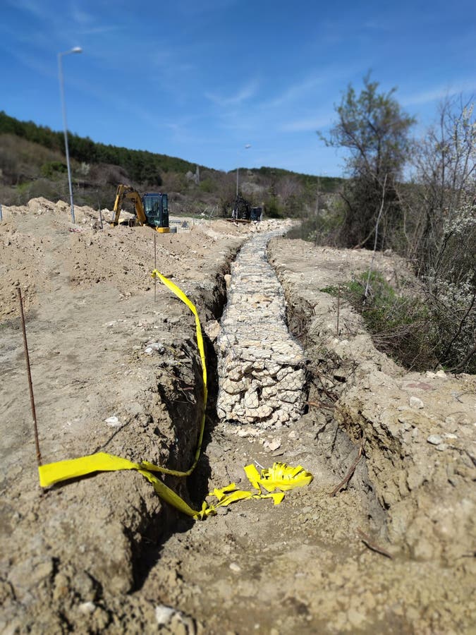 Reinforcing the Edge of the Road with Stones in a Metal Mesh Stock ...