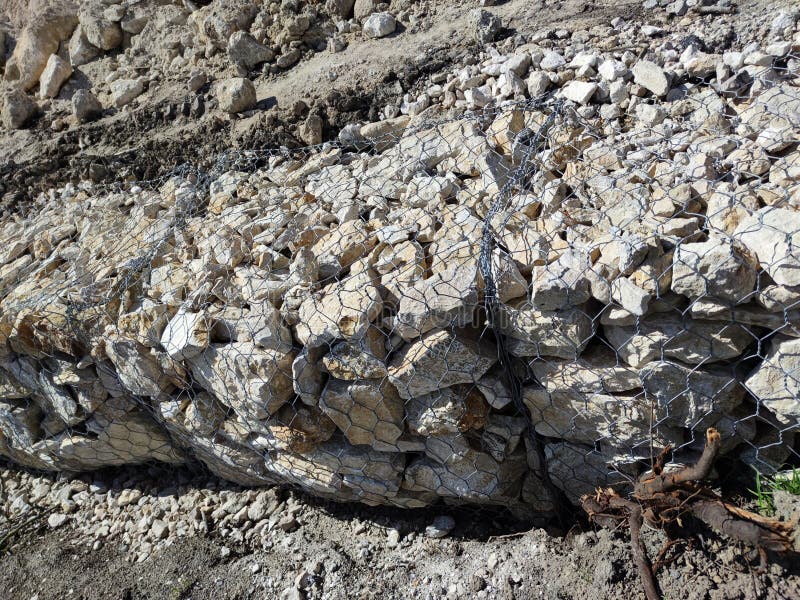 Reinforcing the Road with Stones in a Metal Mesh Stock Image - Image of ...