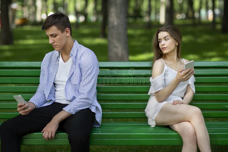 Relationship Problem. Bored Millennial Couple Using Phones on Dull Date ...