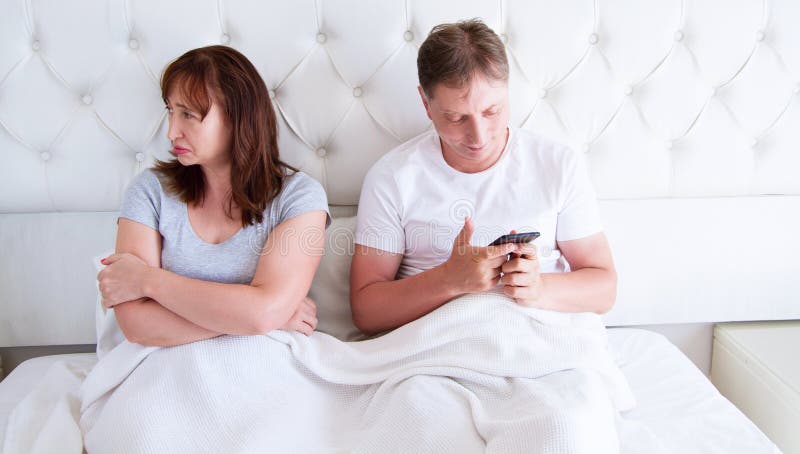Relationship Problems Concept - a Middle-aged Couple Lying in Bed in ...