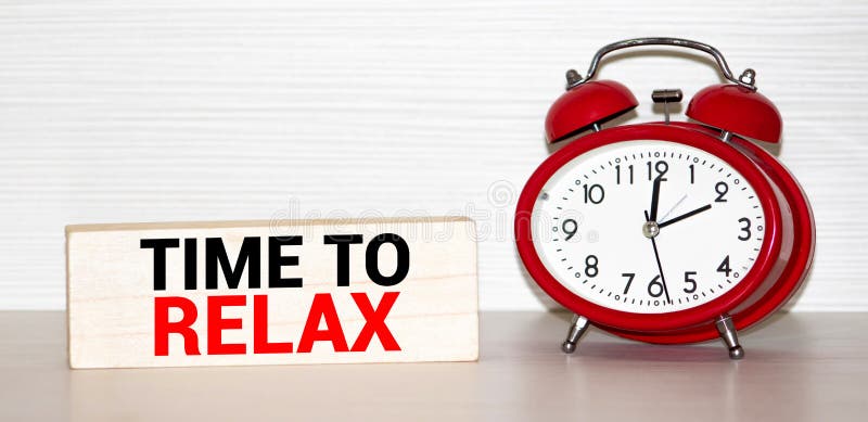RELAX TIME Words on Sticker, Next To an Alarm Clock on a Wooden Table ...