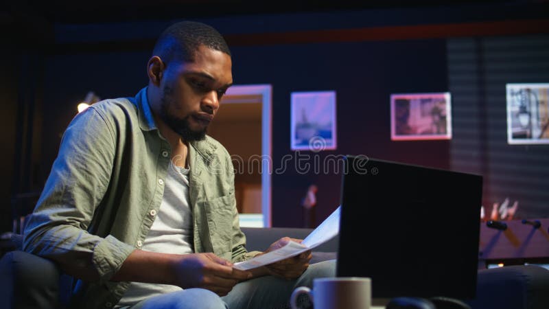 Relaxed Black Man Scrolling on His Smartphone in a Comfortable Space ...