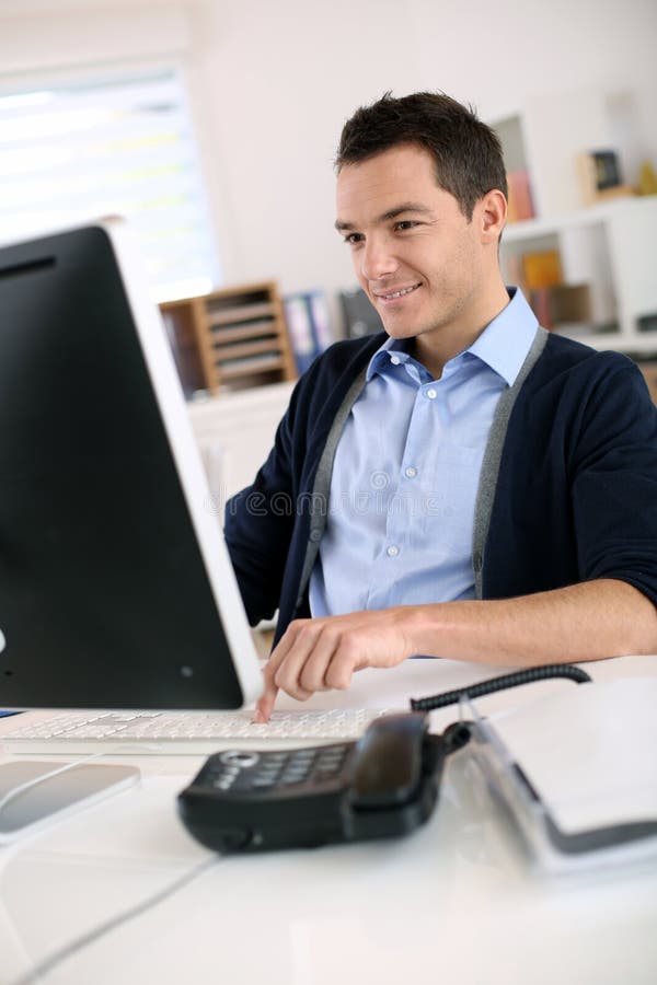Man Sitting at Desk and Working with Computer Stock Photo - Image of ...