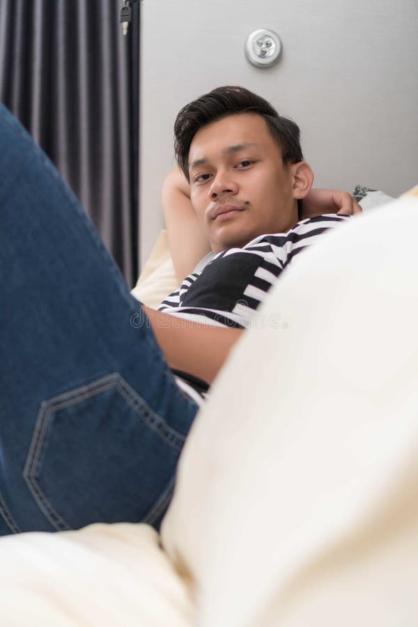 Relaxed Casual Man Lying on the Bed at Home Stock Photo - Image of chat ...