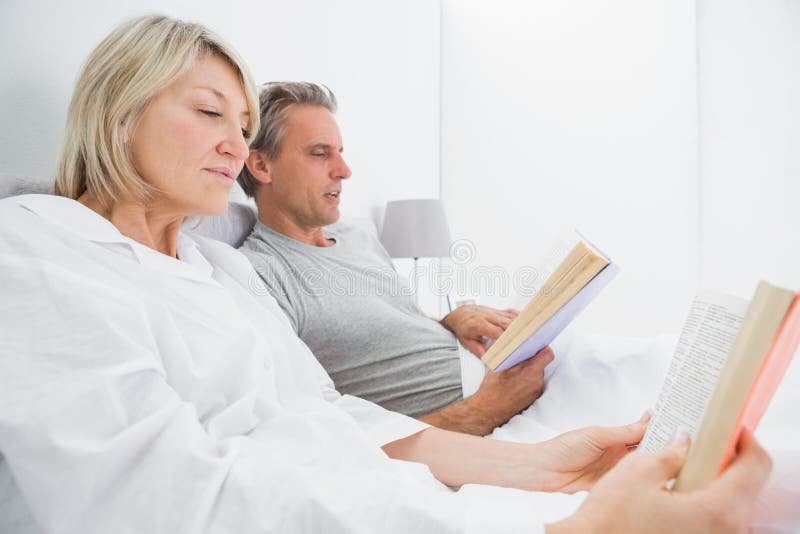 Relaxed Couple Reading Books in Bed Stock Photo - Image of duvet ...