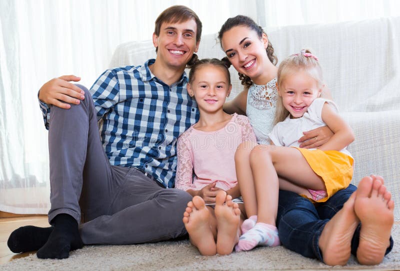 Relaxed Family of Four Posing Stock Photo - Image of positive, european ...