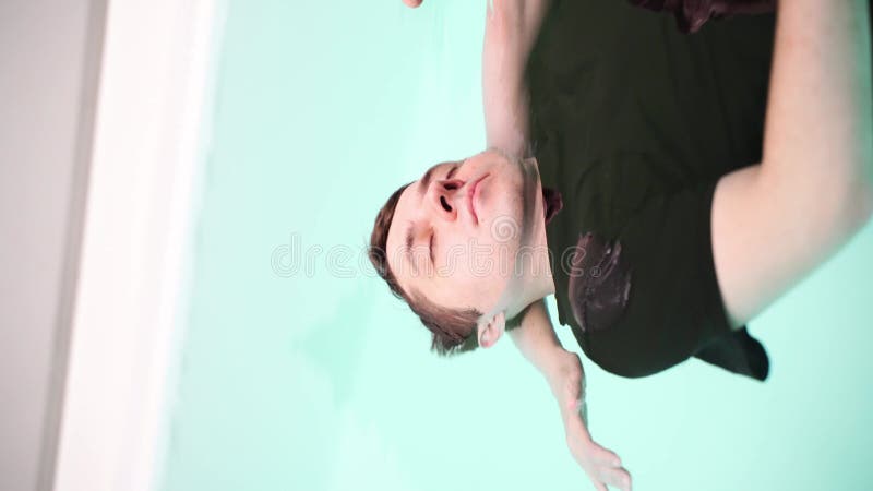 Relaxed Floating Man in Tranquil Pool with Gentle Movements and Serene ...