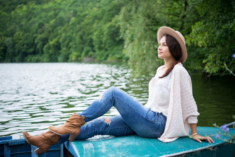 Relaxed Girl Sitting in a Boat on a Lake Stock Photo - Image of water ...