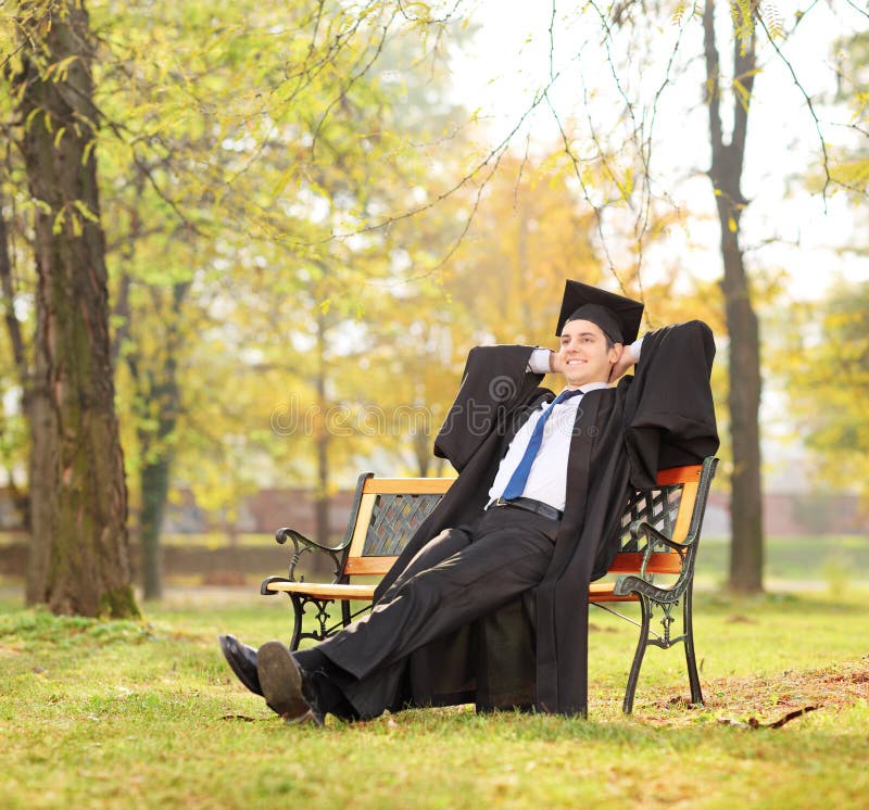 Relaxed Graduate Student Lying on a Grass Field Stock Image - Image of ...