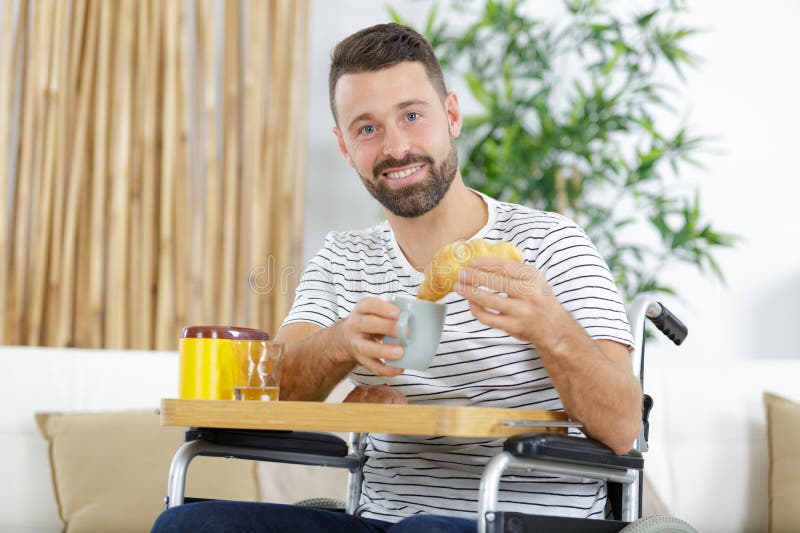 Relaxed Handsome Man in Wheelchair Having Breakfast Stock Image - Image ...