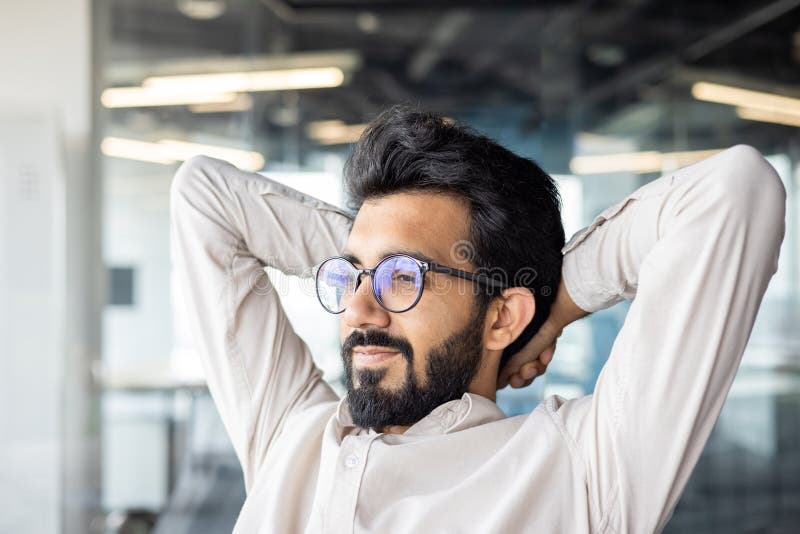 Relaxed Indian Businessman with Beard Taking a Break at Work, Sitting by Office Desk Stock Image ...