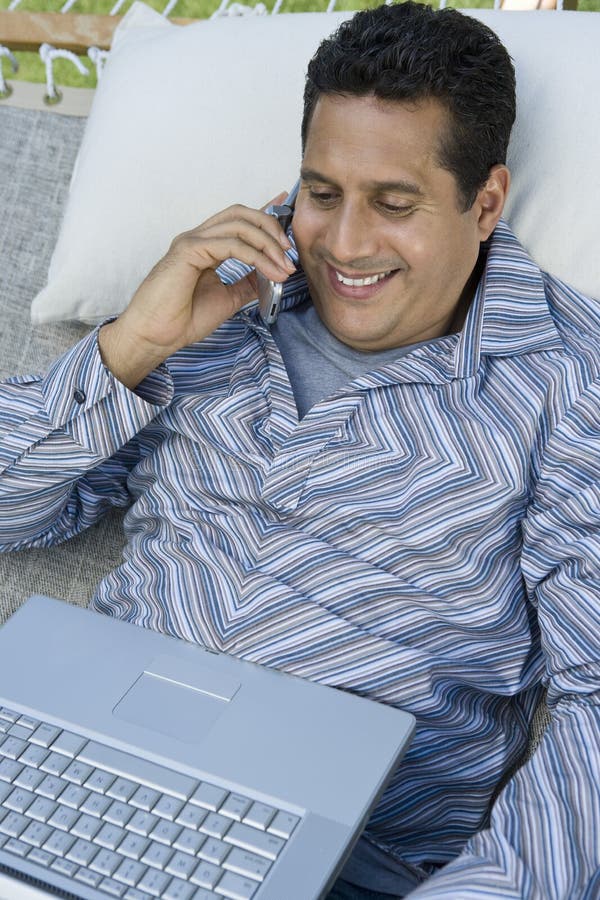 Relaxed Man on Hammock Using Cell Phone Stock Image - Image of looking ...