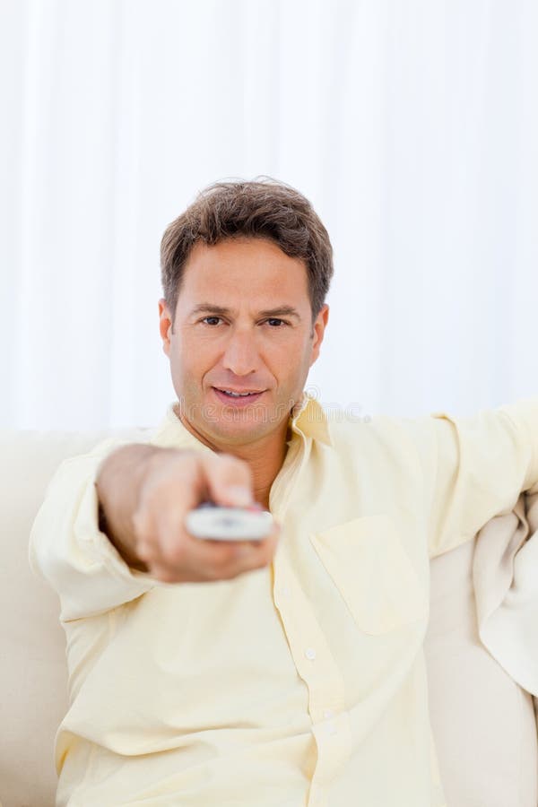 Relaxed Man Pointing a Remote To the Camera Stock Photo - Image of ...