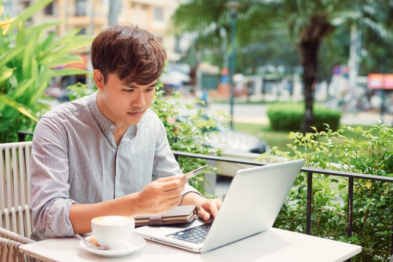 Relaxed Man Writing in a Laptop in a Coffee Shop Stock Image - Image of ...