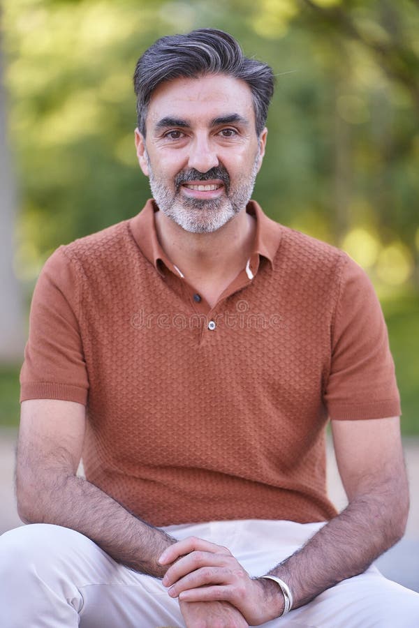 Relaxed Middle-aged Man Looking at Camera while Standing Outdoors in a ...