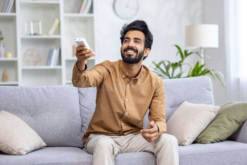 Young Man Air Conditioner Remote Control Freezing Sofa Stock Photos ...