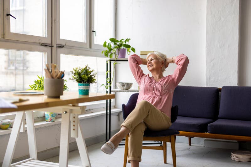 Relaxed Senior Woman Sitting in the Office Stock Photo - Image of ...