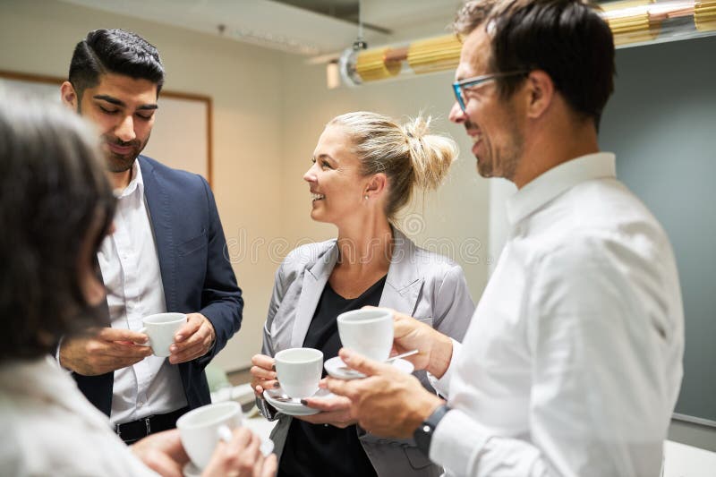 Relaxed Small Talk Over a Cup of Coffee during a Break Stock Photo ...