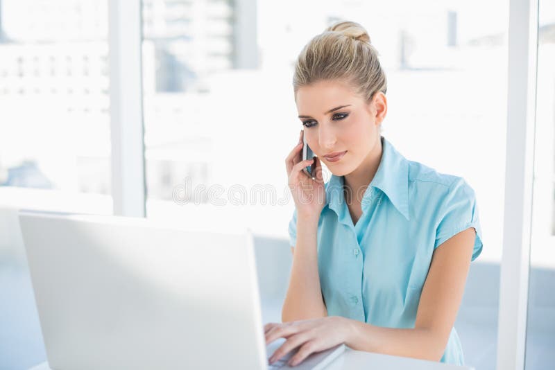 Relaxed Smart Businesswoman on the Phone while Using Laptop Stock Image ...